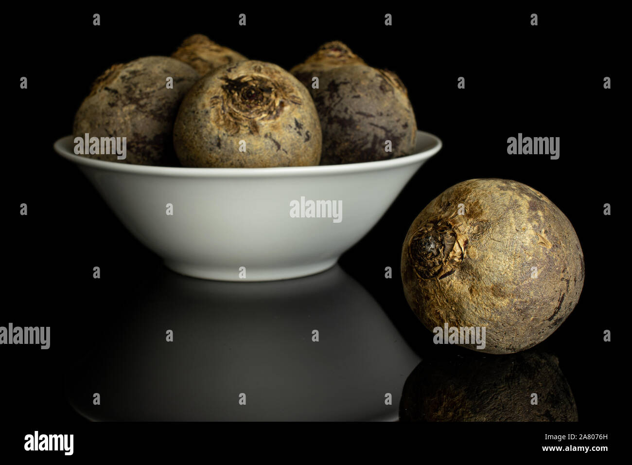Group of six whole raw red beetroot in white ceramic bowl isolated on ...