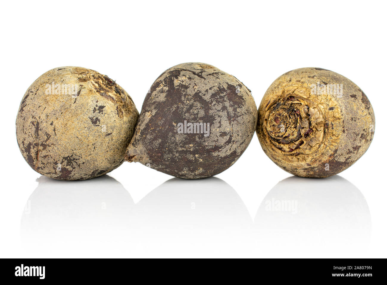 Group of three whole raw red beetroot in row isolated on white ...