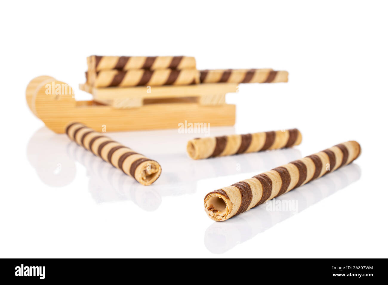 Lot of whole crunchy beige hazelnut rolled wafer biscuit with wooden ...