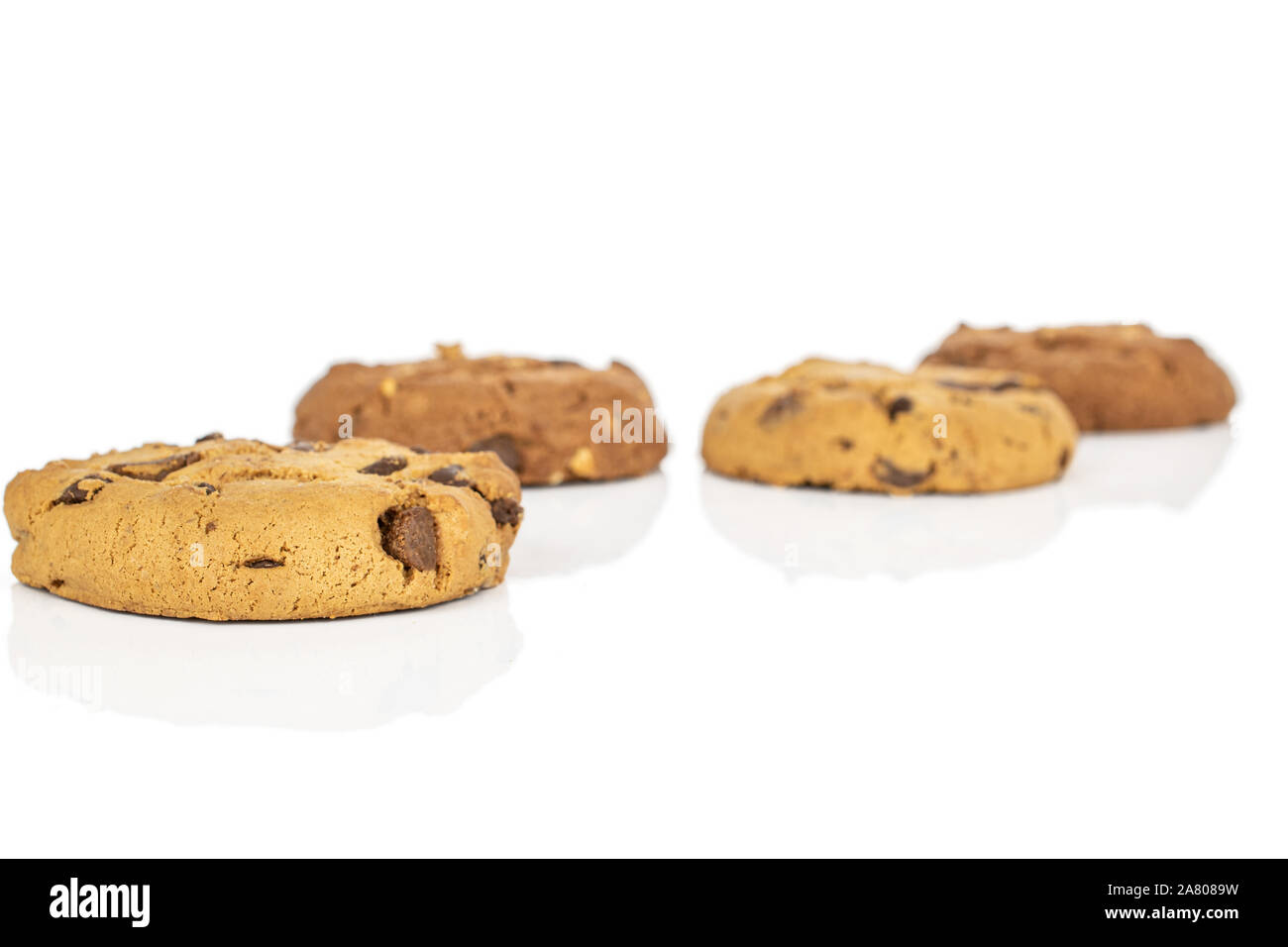 Group of four whole sweet brown cookie front focus isolated on white ...