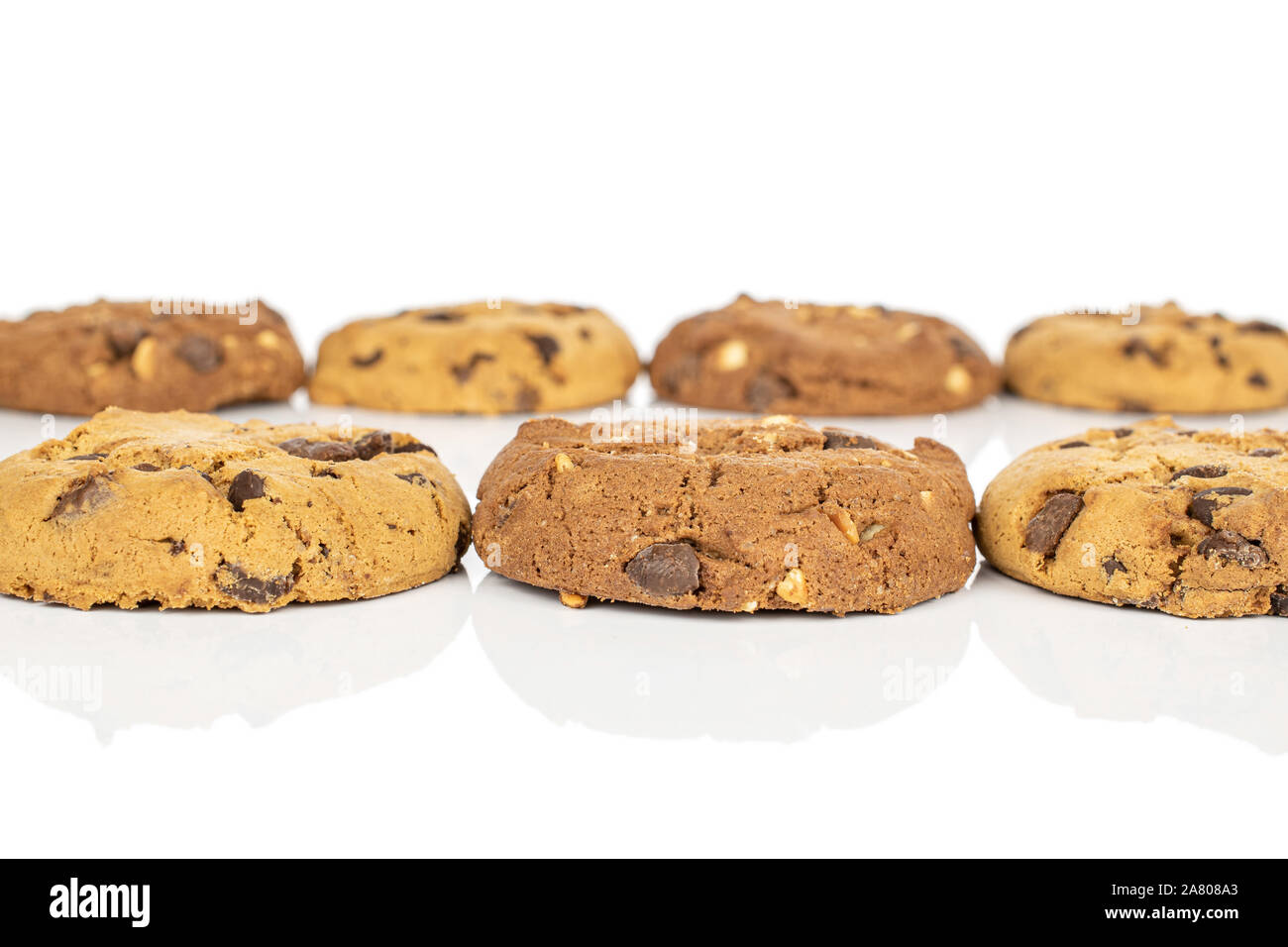 Group of seven whole sweet brown cookie isolated on white background ...