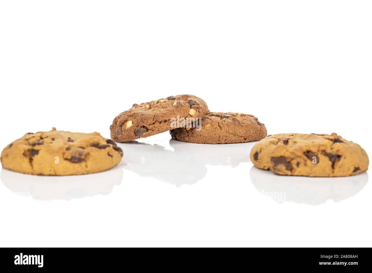 Group of four whole arranged sweet brown cookie isolated on white ...