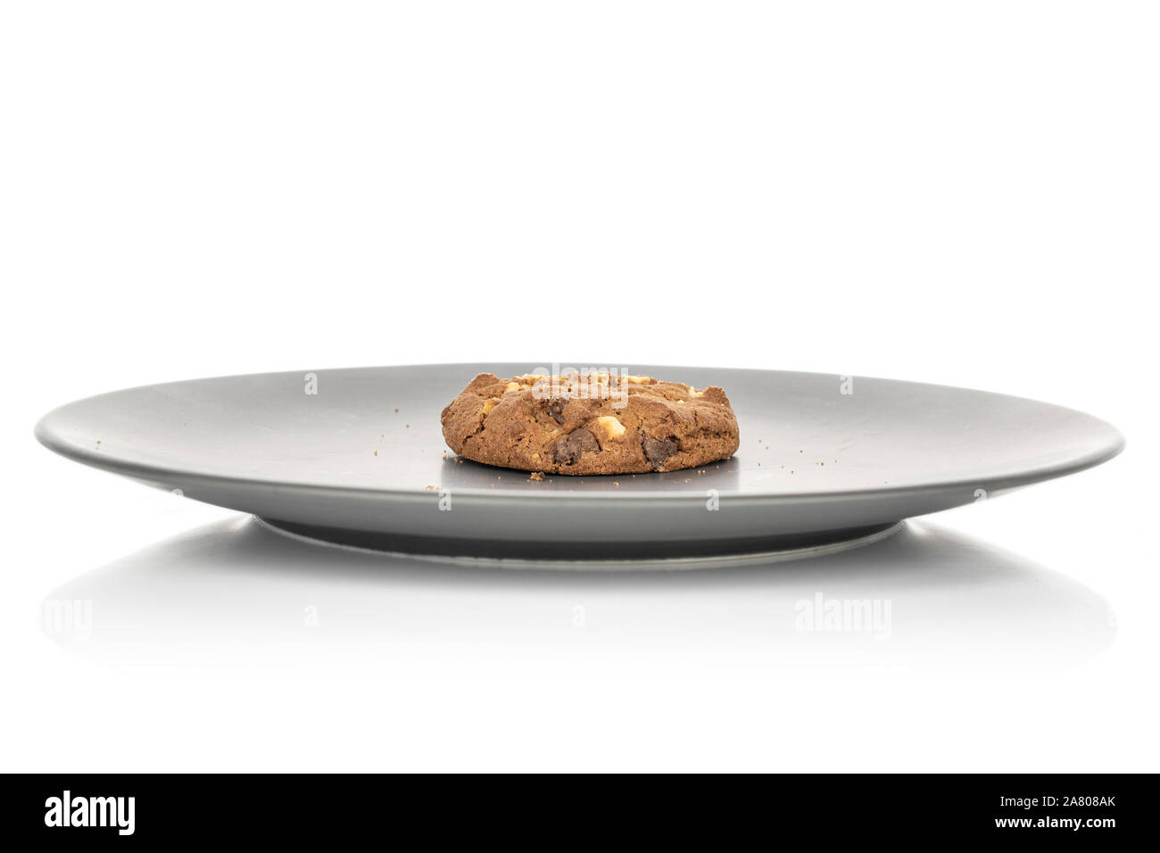 One half of sweet brown cookie in glazed bowl isolated on white ...