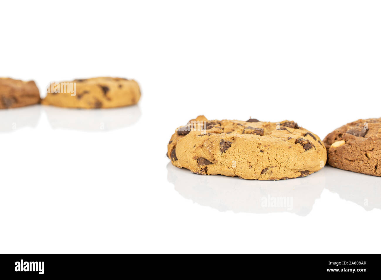 Group of four whole sweet brown cookie isolated on white background ...