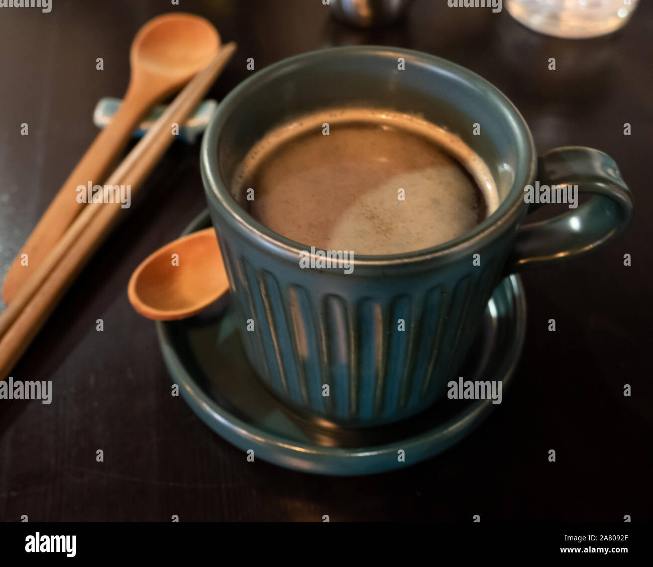 Coffee cup on table in trendy setting Stock Photo - Alamy