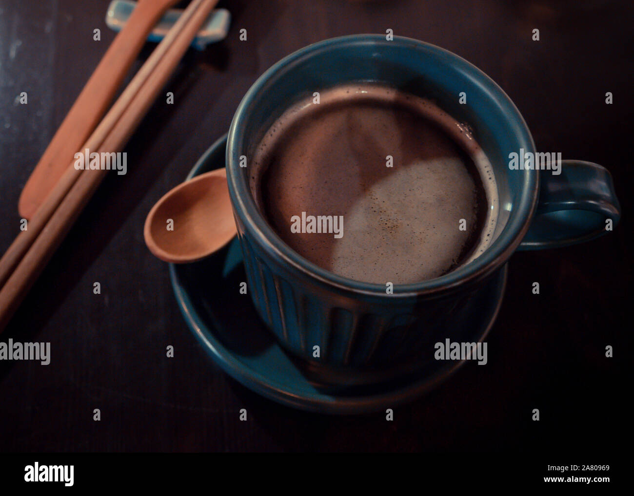 Coffee cup on table in trendy setting Stock Photo - Alamy