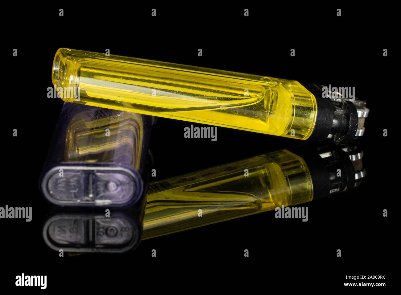 Group of two whole plastic lighter isolated on black glass Stock Photo ...