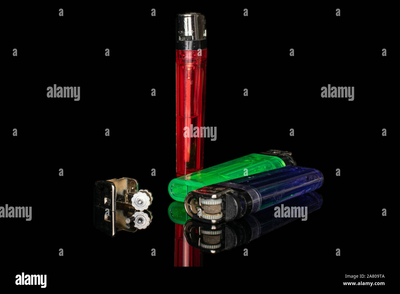 Group of three whole four pieces of plastic lighter isolated on black ...