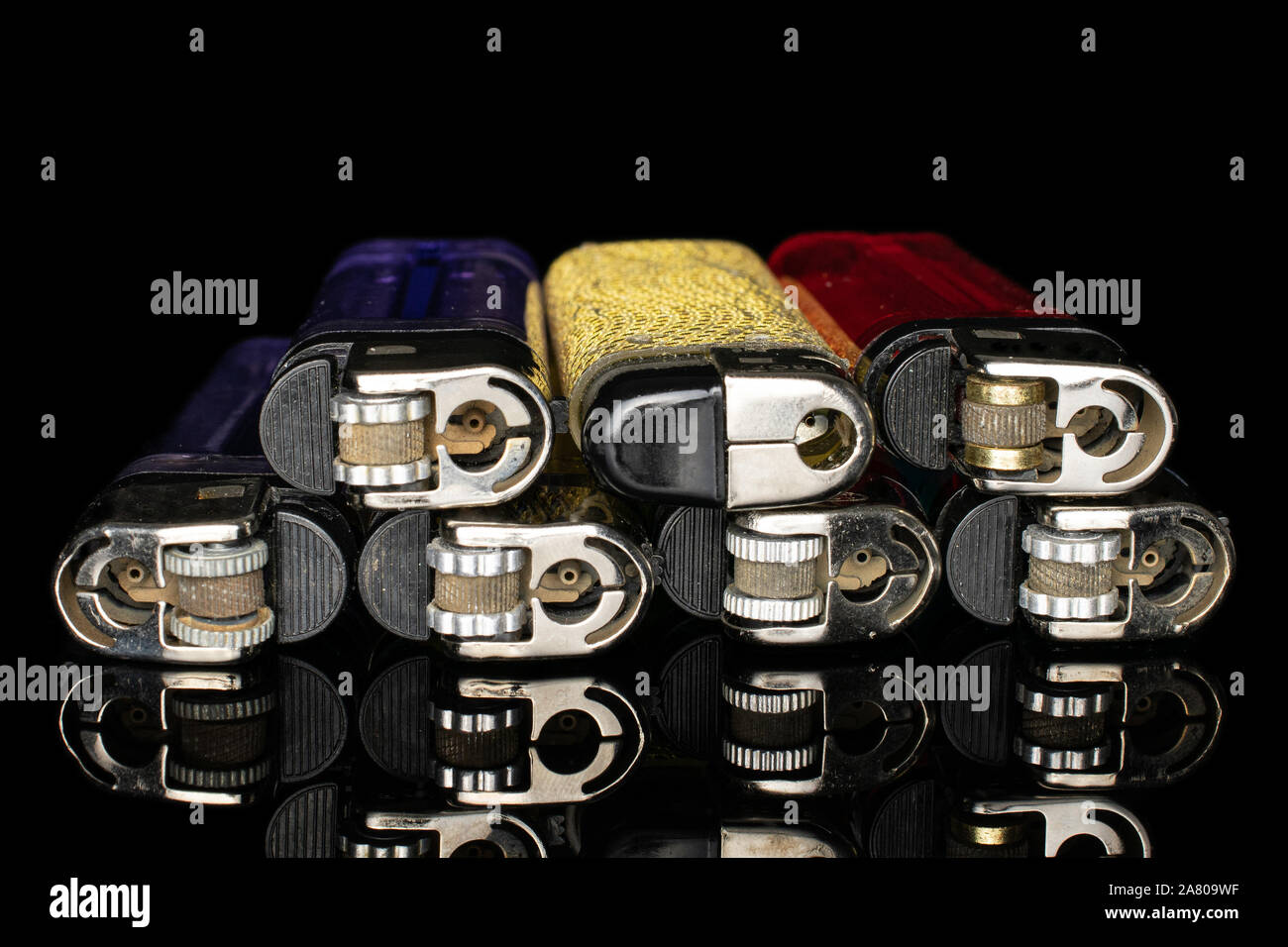 Group of seven whole plastic lighter isolated on black glass Stock ...