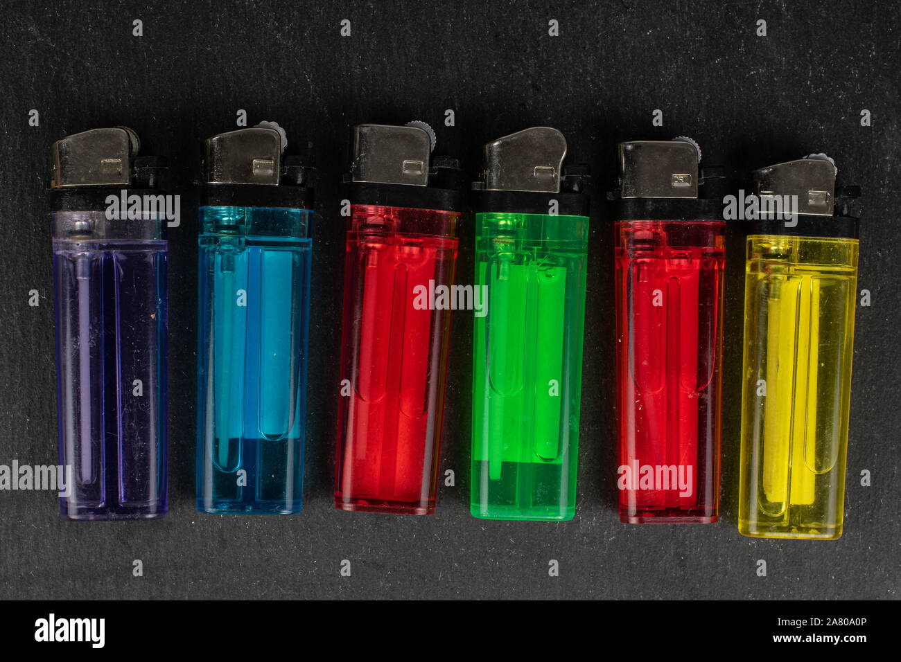 Group of six whole plastic lighter flatlay on grey stone Stock Photo ...