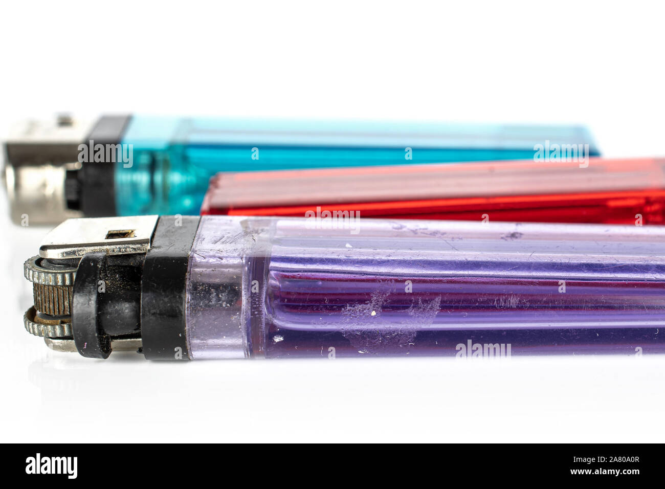 Group of three whole plastic lighter front focus isolated on white ...