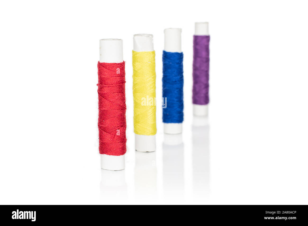 Group of four whole sewing thread spool isolated on white background ...