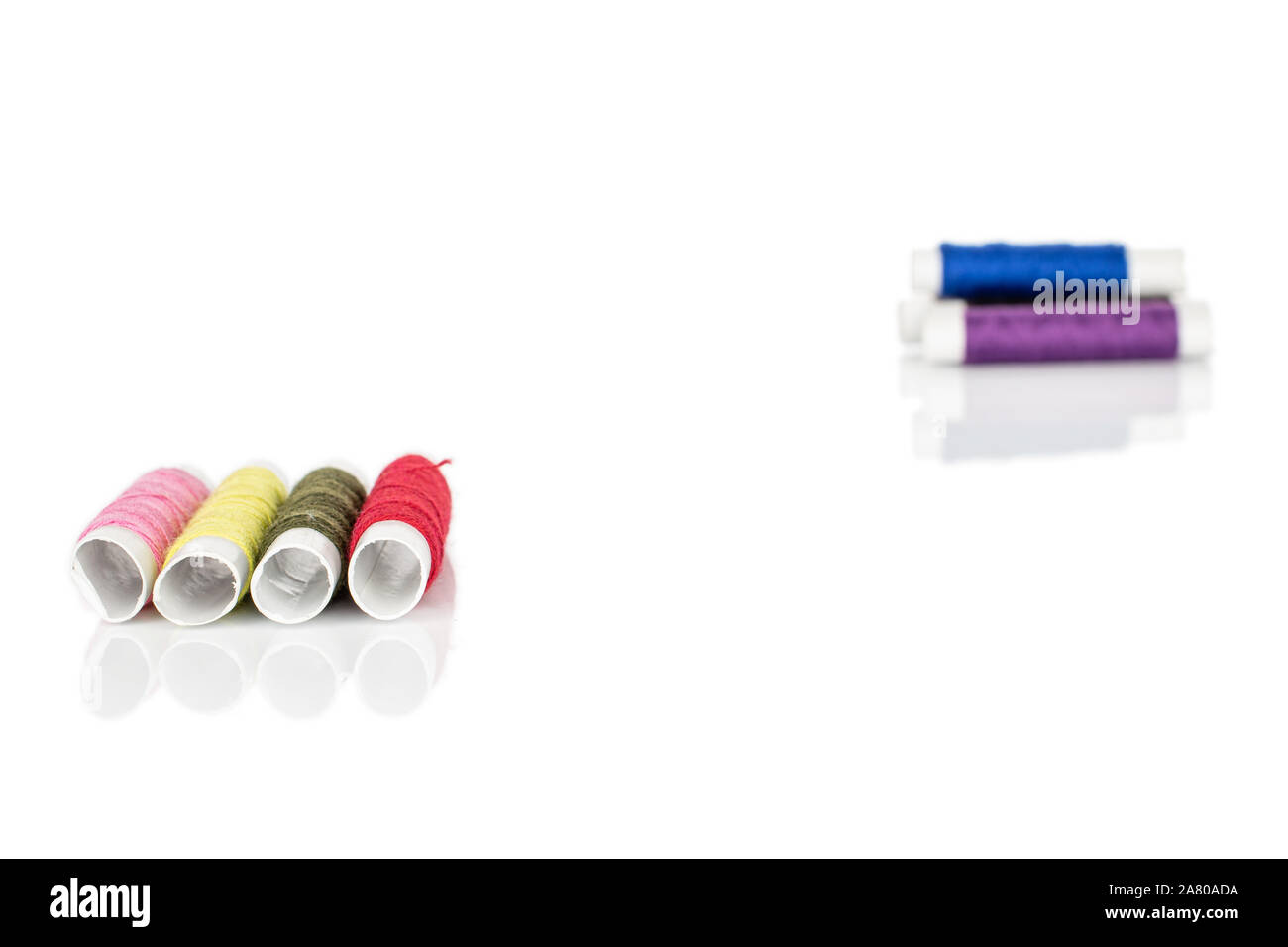 Group of seven whole arranged sewing thread spool isolated on white ...