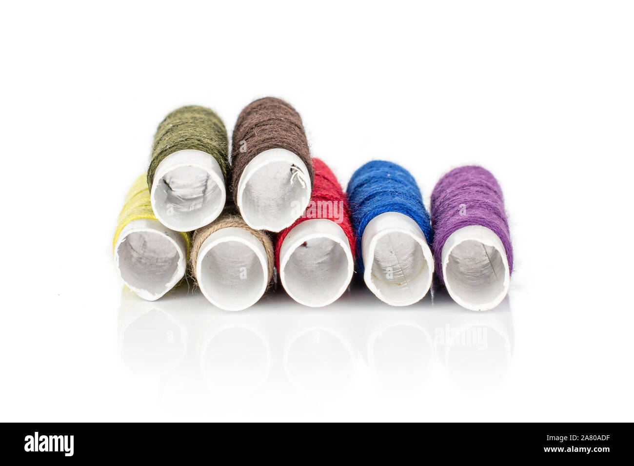 Group of seven whole sewing thread spool isolated on white background ...