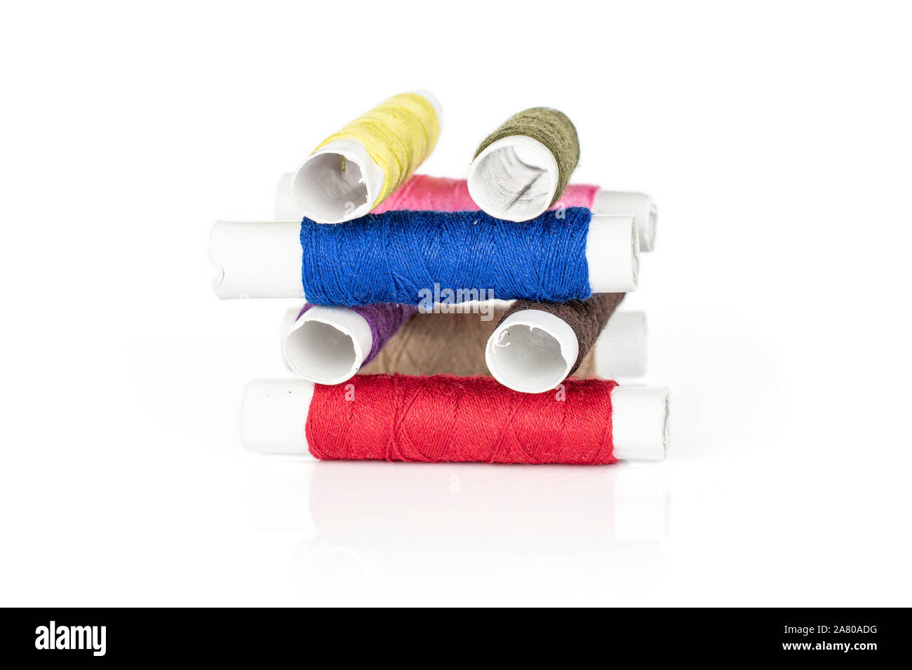Group of eight whole sewing thread spool tower isolated on white ...
