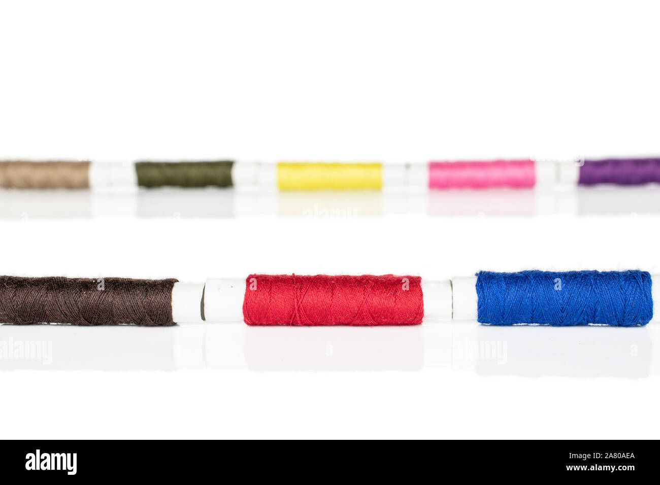 Group of eight whole sewing thread spool in line isolated on white ...
