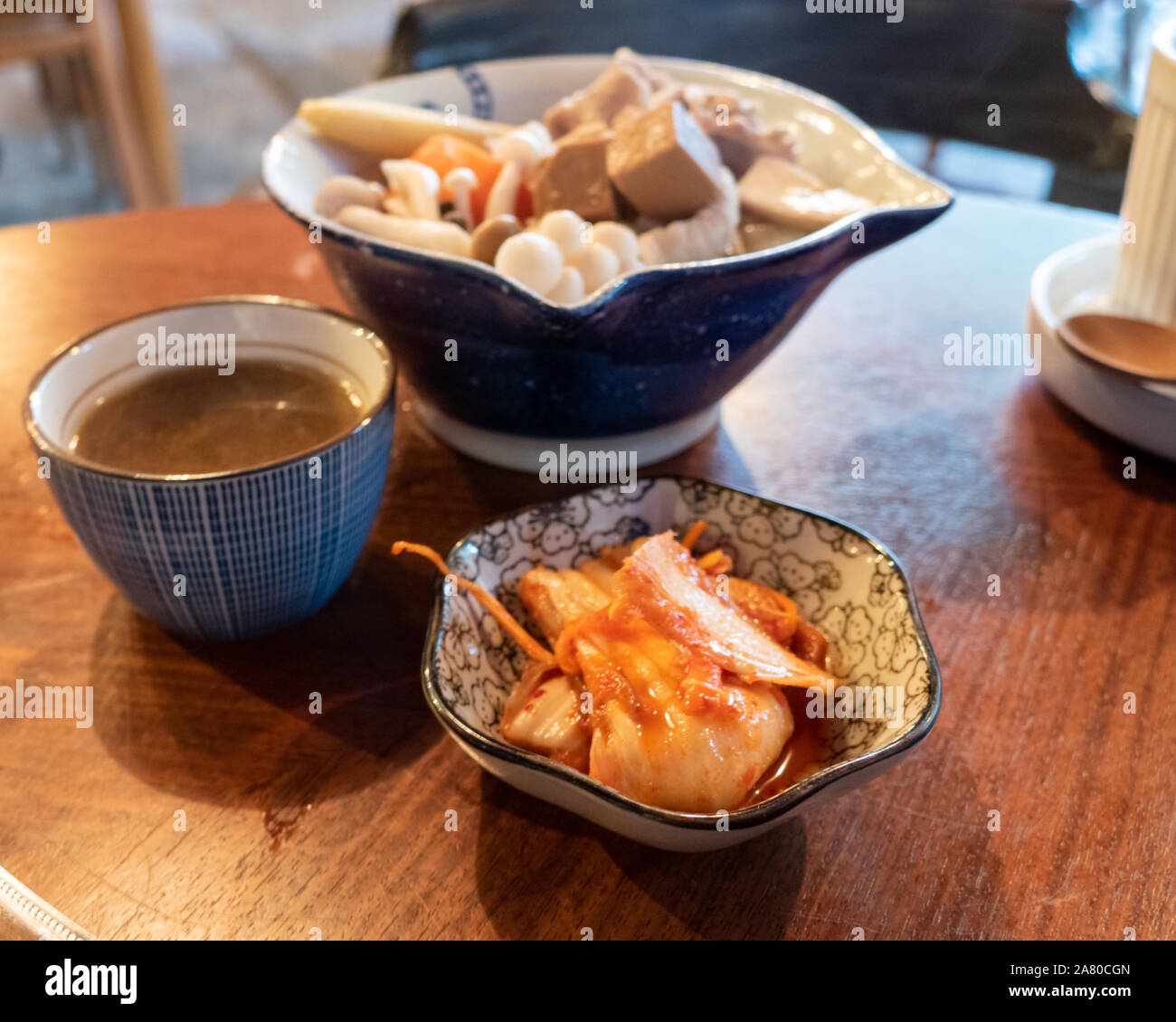 Asian kimchi with dishes in background, lunch spread Stock Photo - Alamy