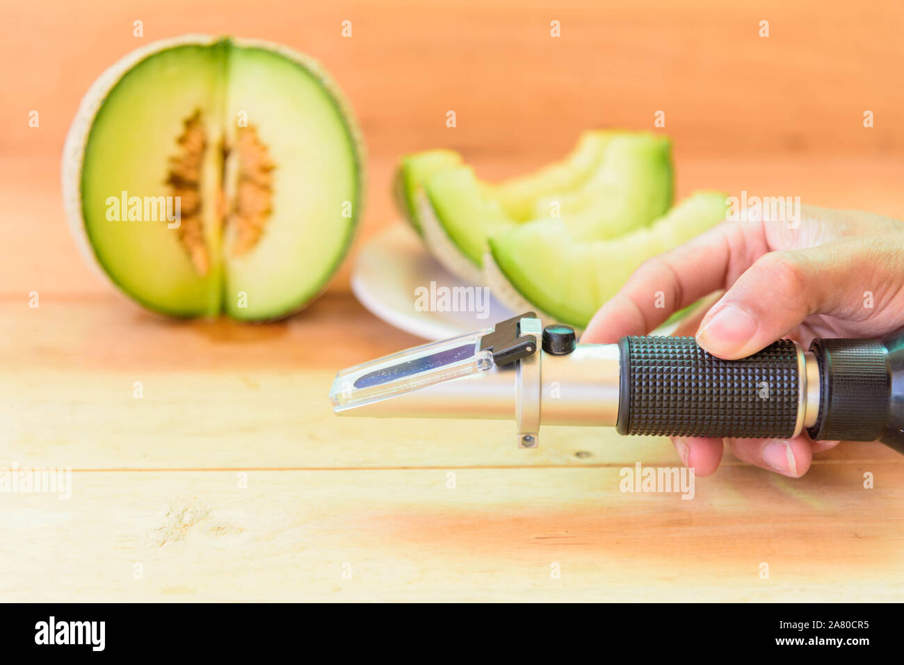 Brix meter for test the sweet of fruit in hand Stock Photo - Alamy