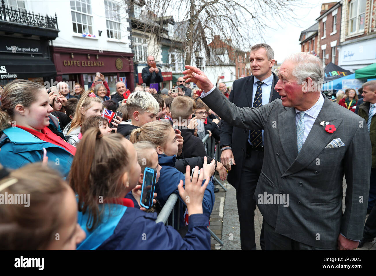 The Prince of Wales is greeted by local children during a visit to Ross ...
