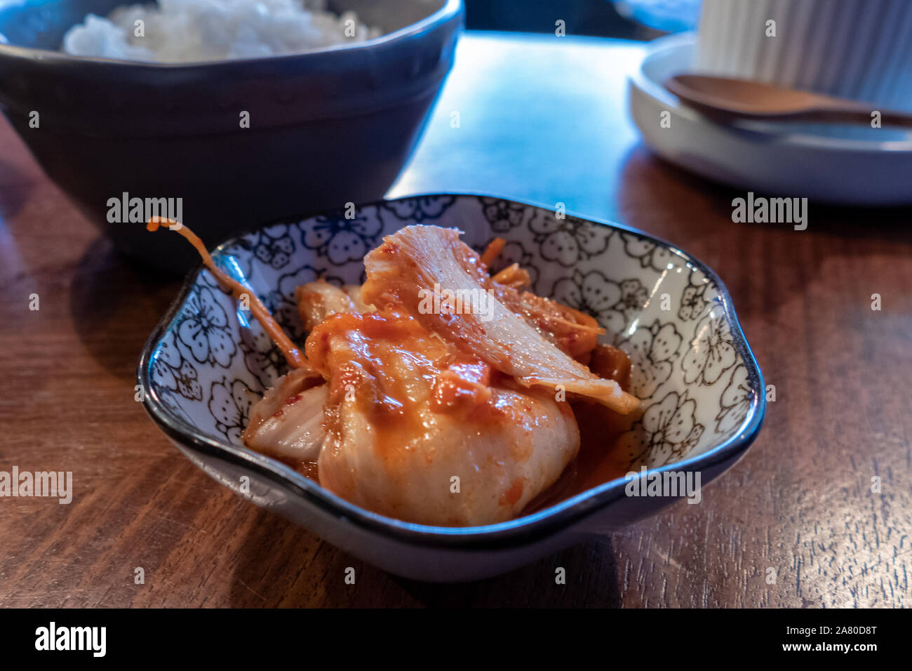 Asian kimchi with dishes in background, lunch spread Stock Photo - Alamy