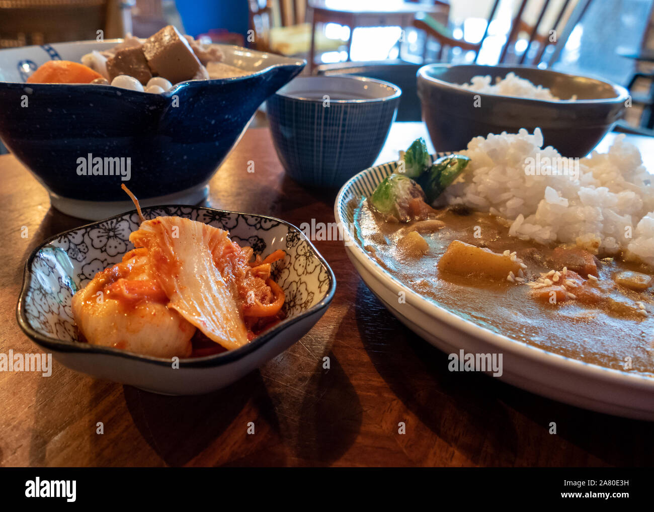 Asian kimchi with dishes in background, lunch spread Stock Photo - Alamy