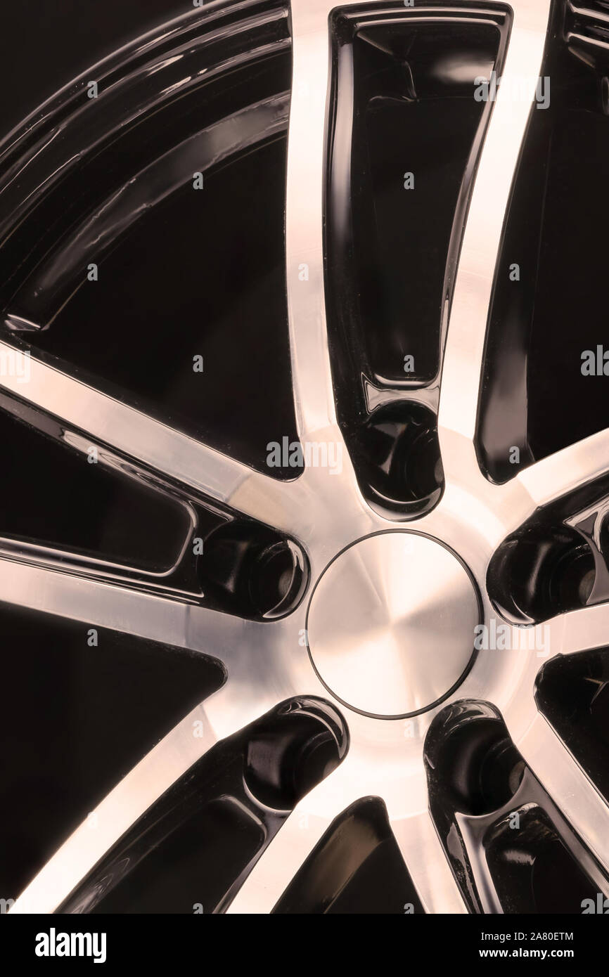 car alloy wheel black and white spokes on black background, element ...
