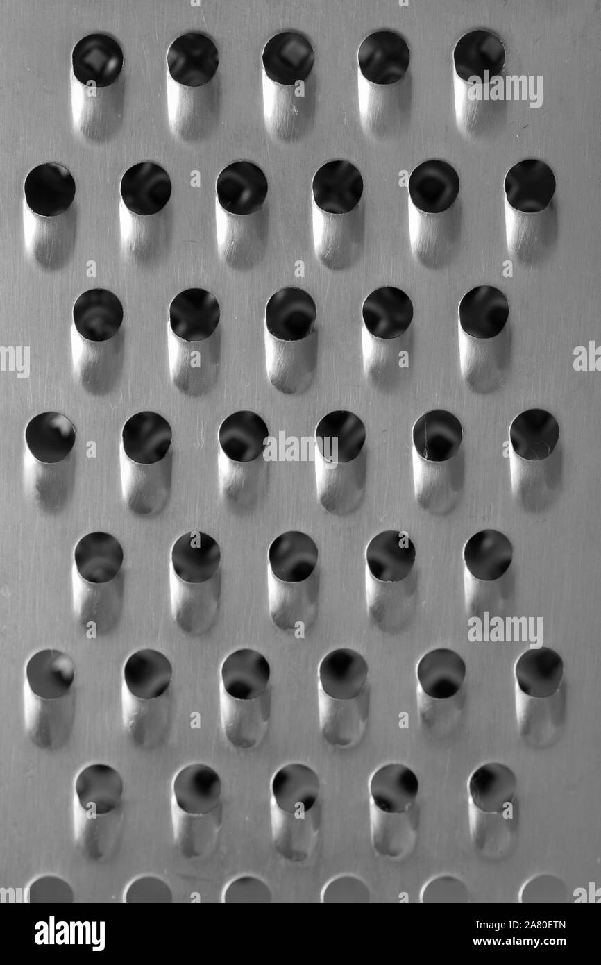 Metal grater, surface with sharp holes, backdrop texture. Gray silver ...