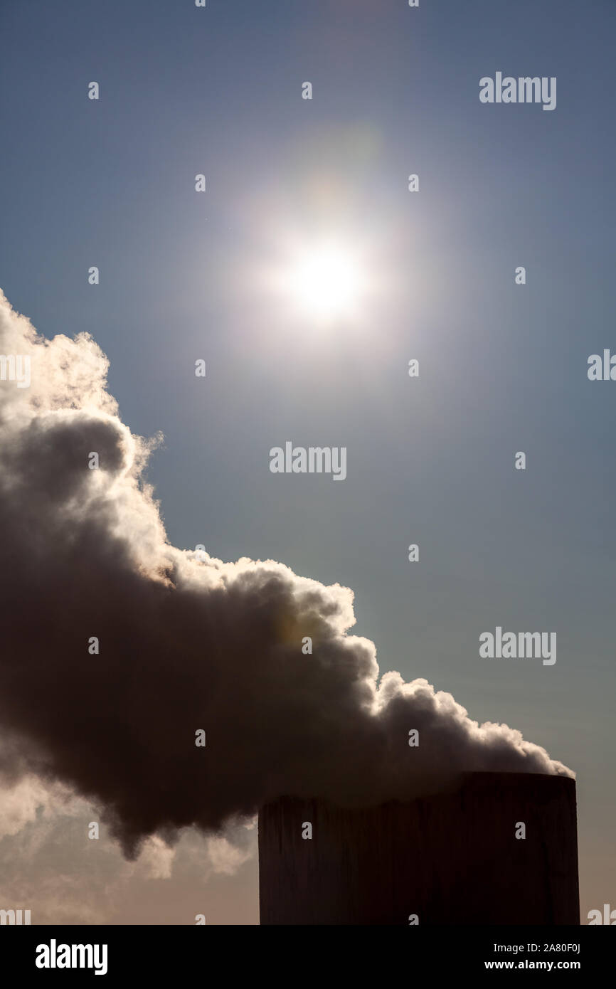 Pollution or smoke coming from the top of a chimney and blocking out ...