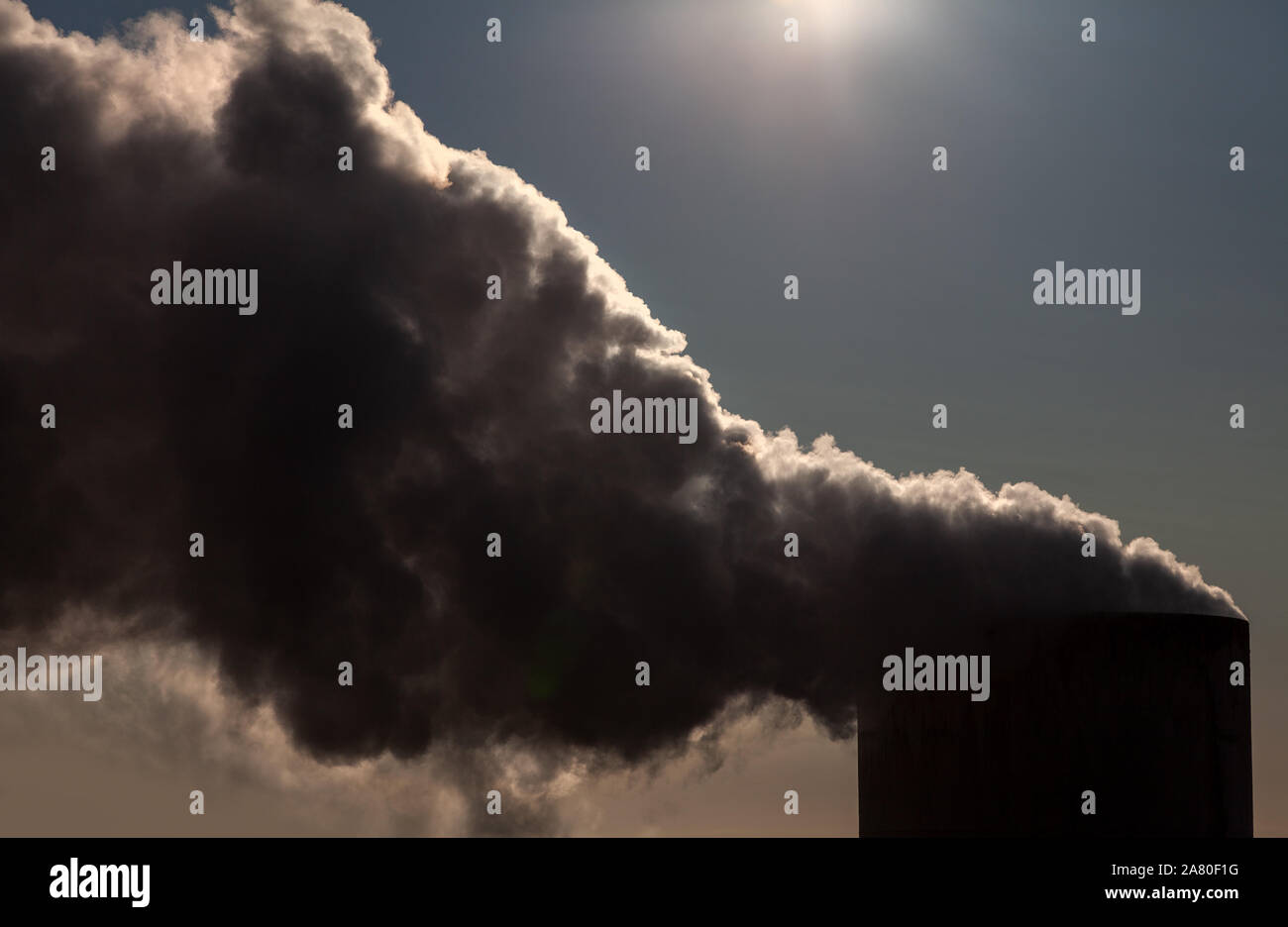 Pollution or smoke coming from the top of a chimney and blocking out ...