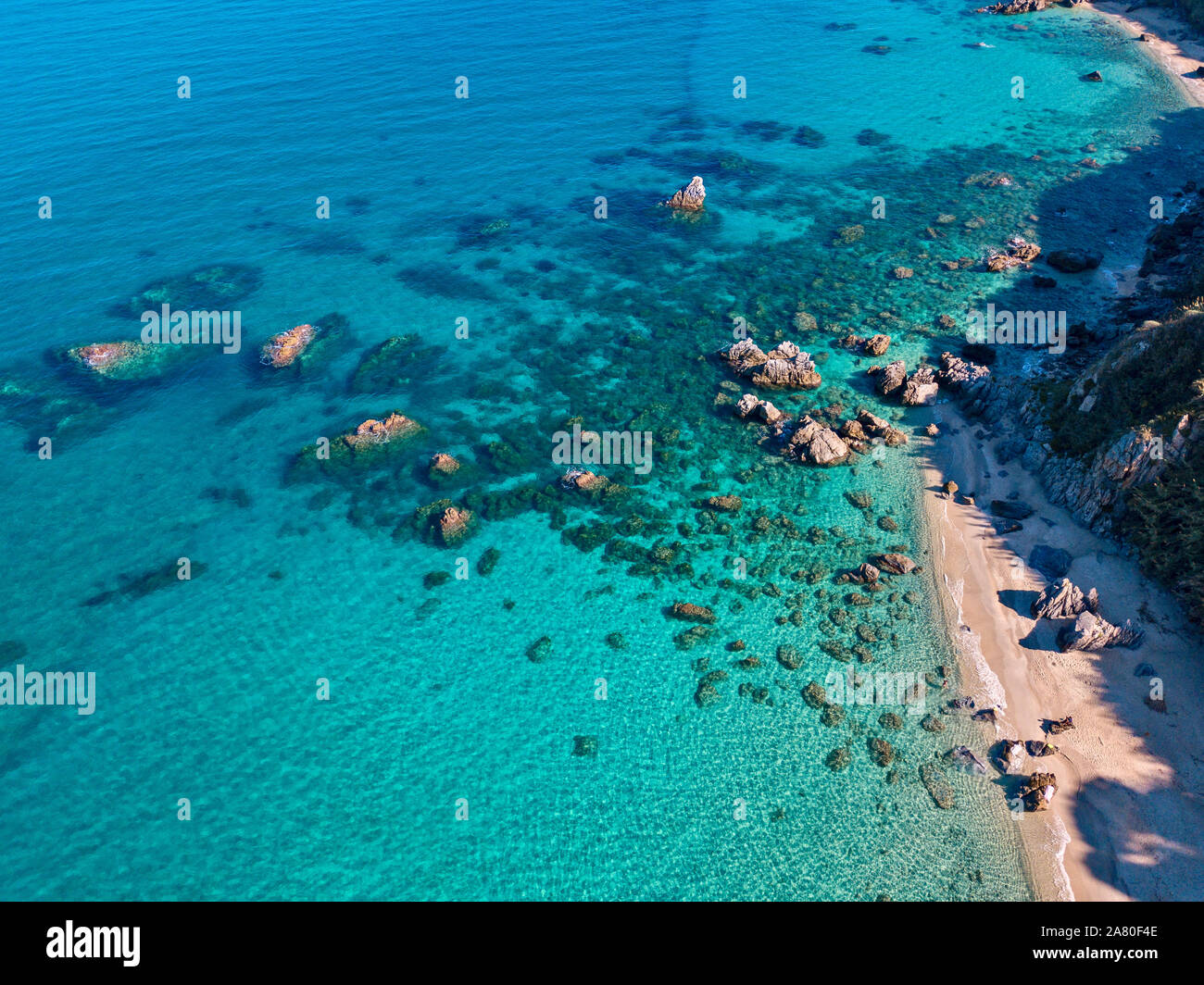 Aerial view of Tropea beach, crystal clear water and rocks on the beach ...