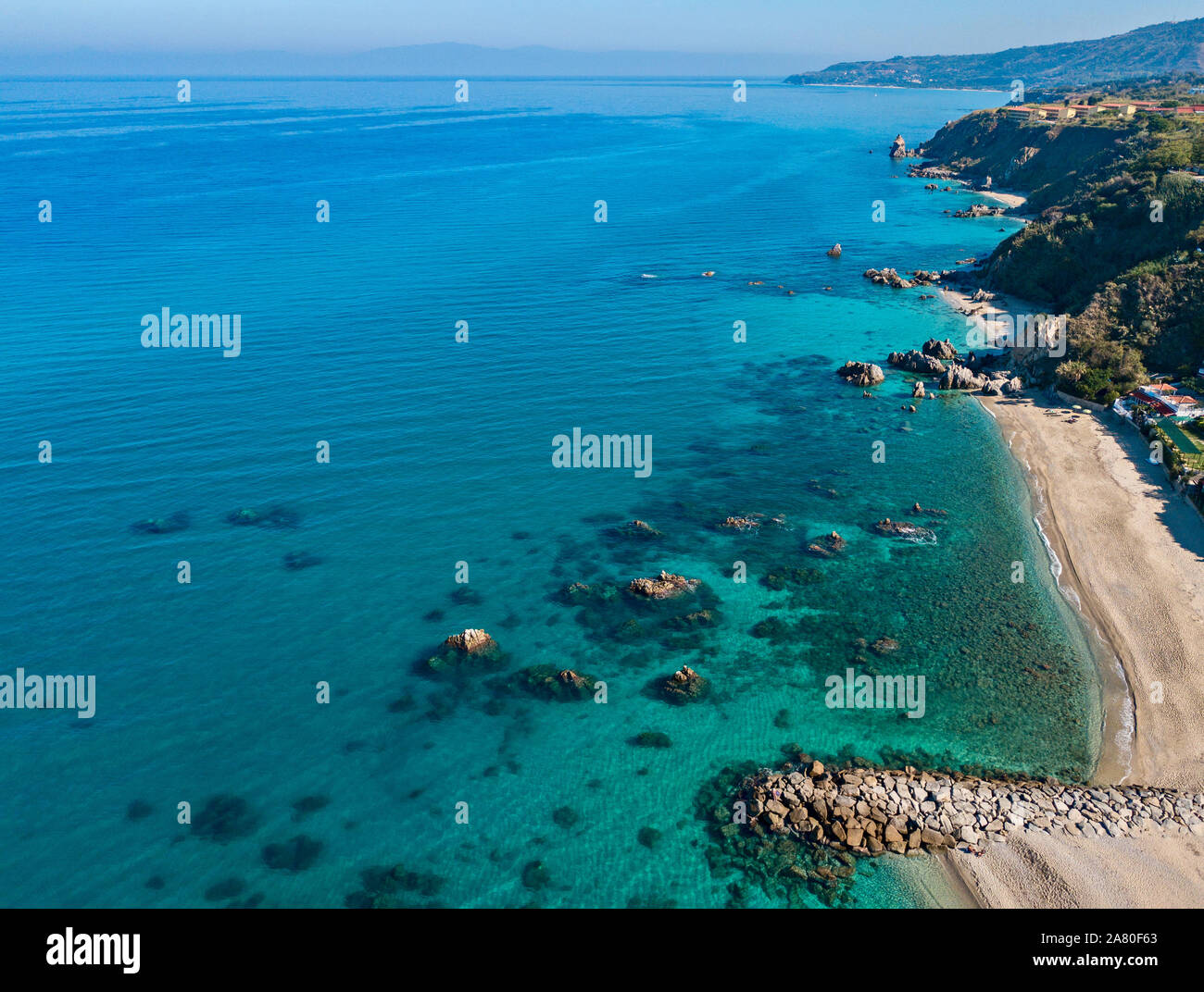 Aerial view of Tropea beach, crystal clear water and rocks on the beach ...