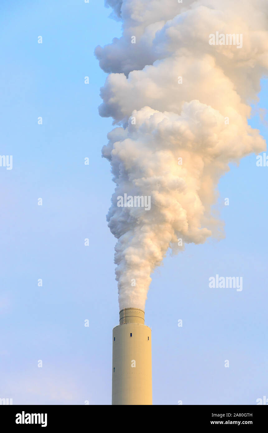 Portrait of an smoke billowing from an industrial chimney into a smoky ...
