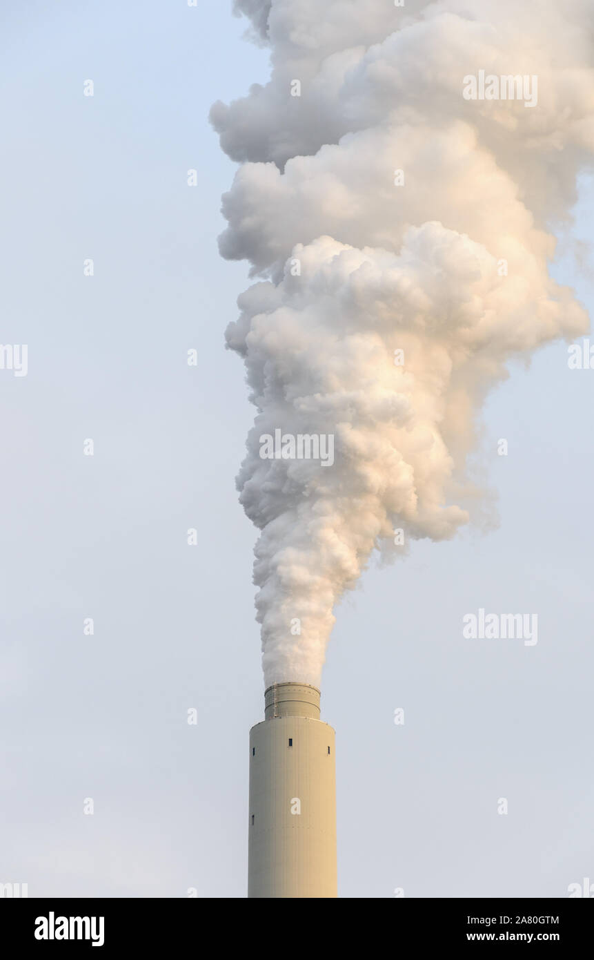 Portrait of an smoke billowing from an industrial chimney into a smoky ...