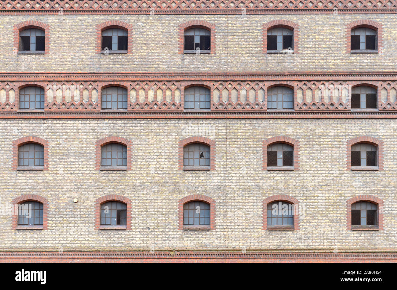 Exterior facade of a brick factory or commercial building with rows of ...
