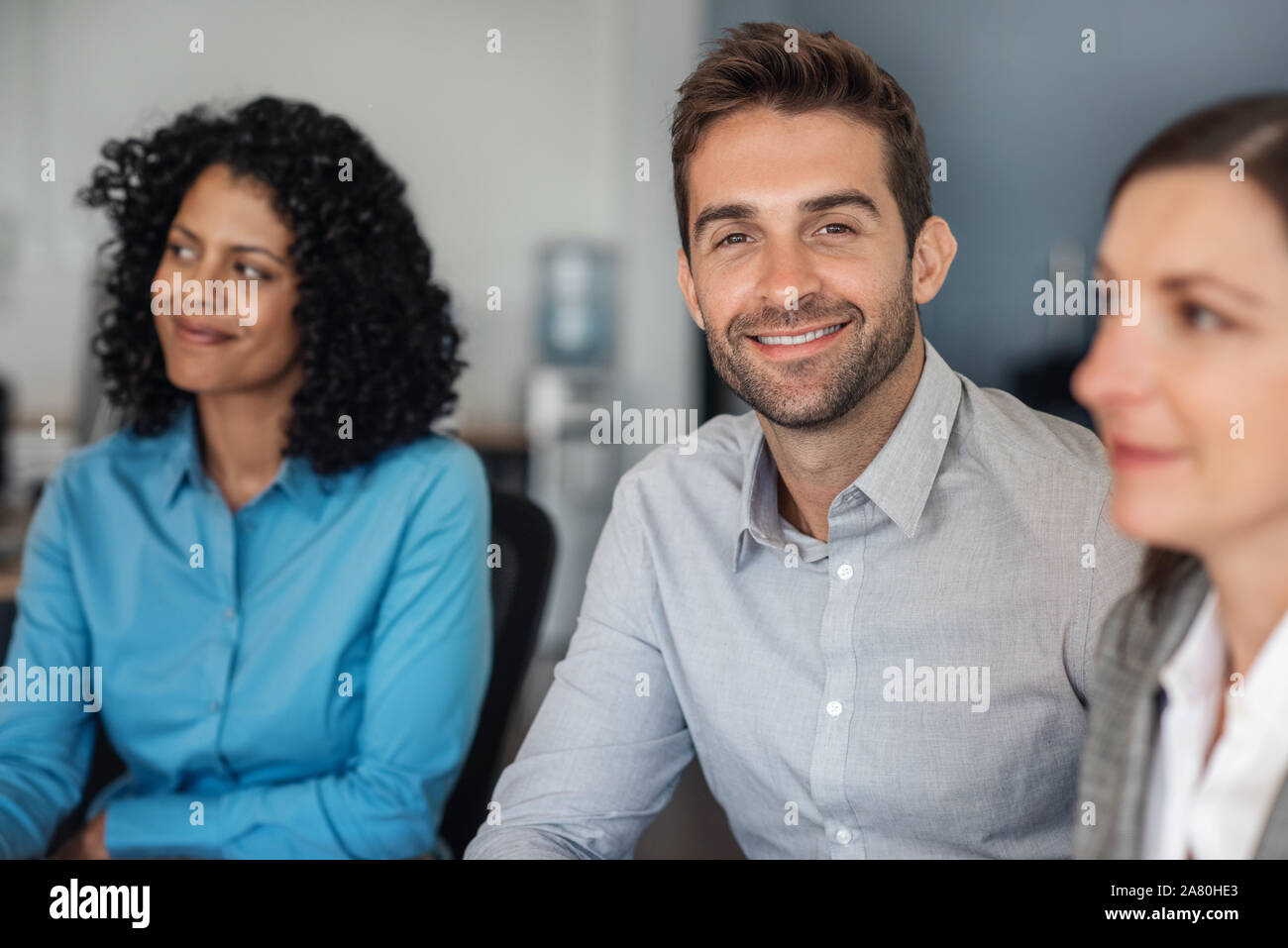 Smiling successful businessmen sitting table hi-res stock photography and images - Alamy