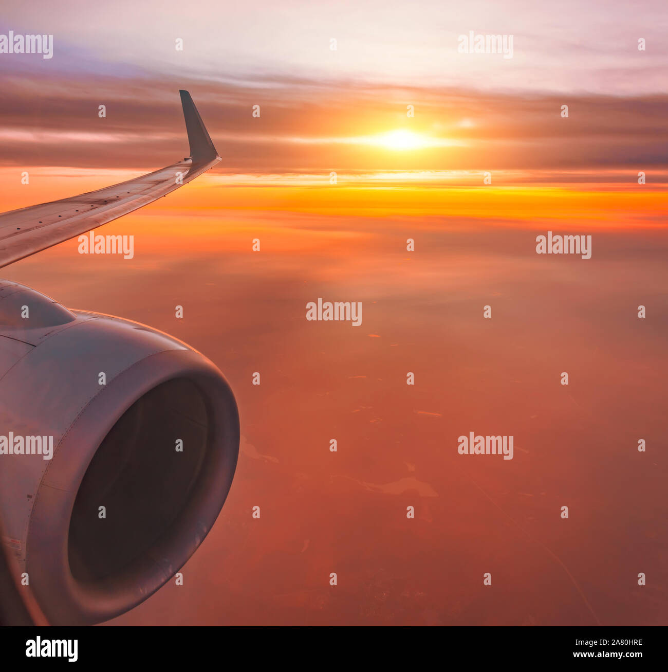 Sunset sky from an airplane side wing engine view of the horizon ...