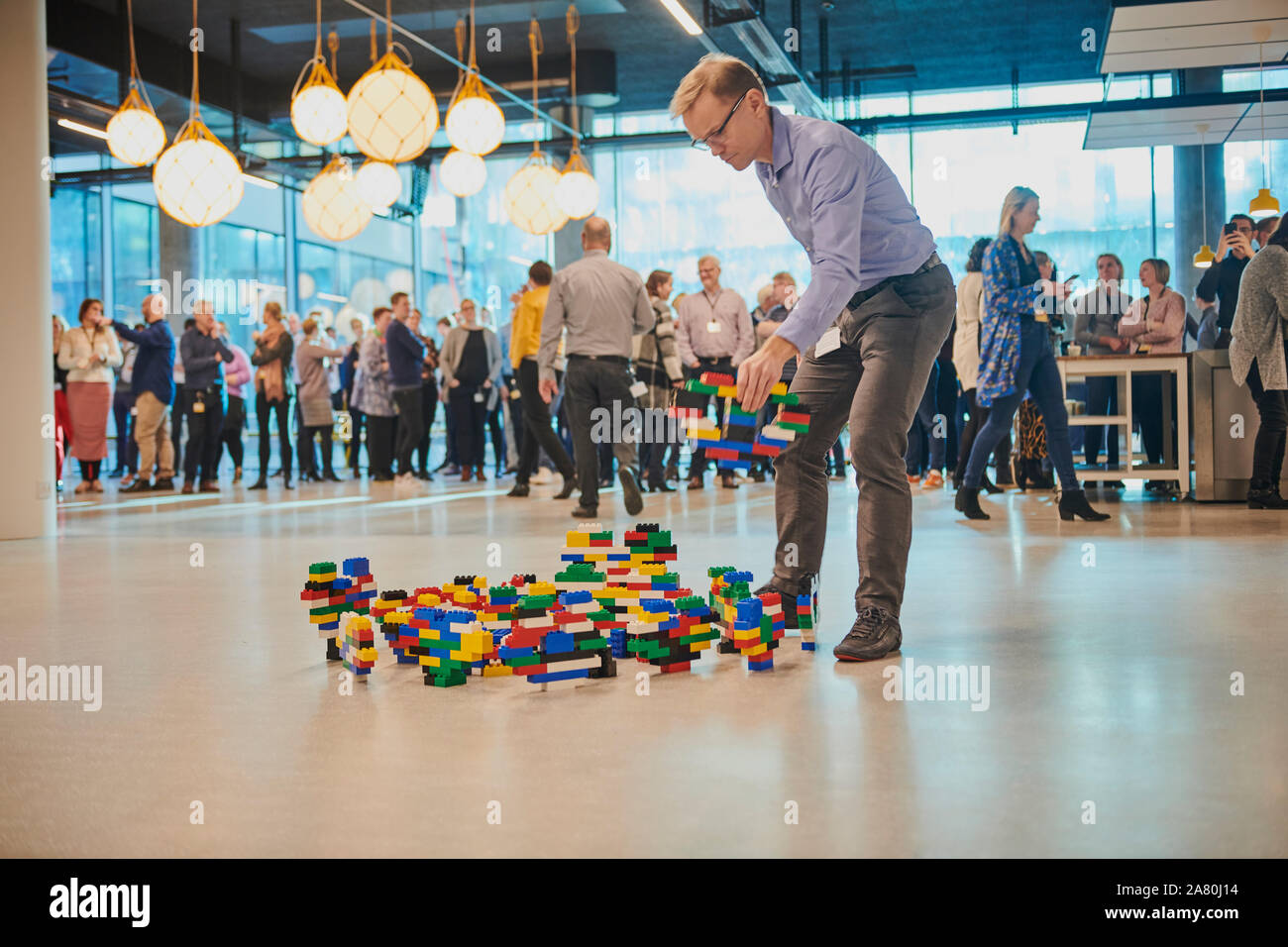 Lego Employee building Lego Challenge Stock Photo - Alamy