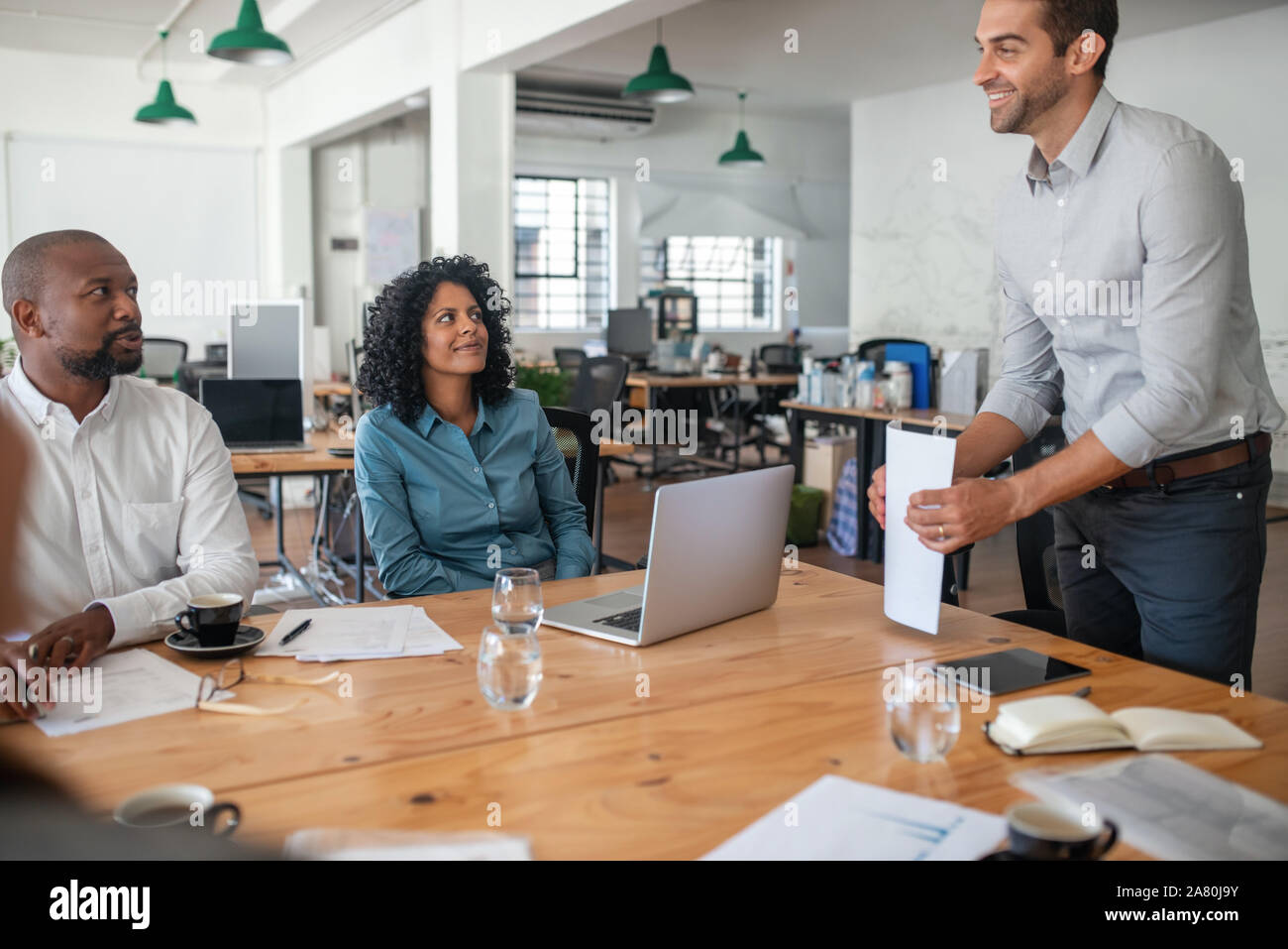 Manager and his smiling staff meeting together in an office Stock Photo ...