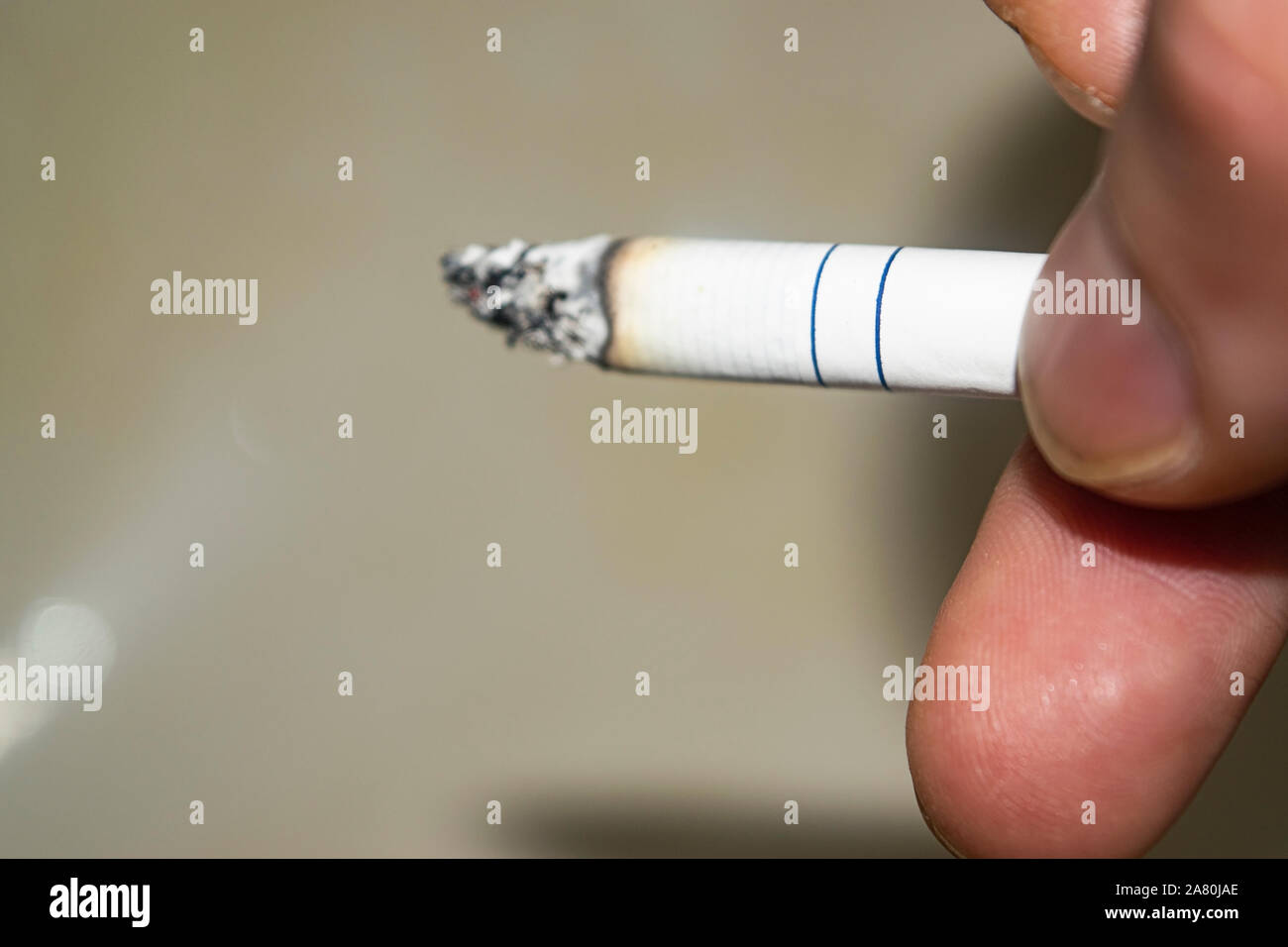 Cigarette in a man's hand concept photo. The dangers of Smoking ...