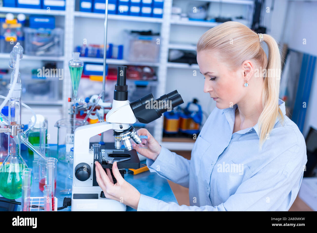 Doctor uses medical microscope expertise hi-res stock photography and ...