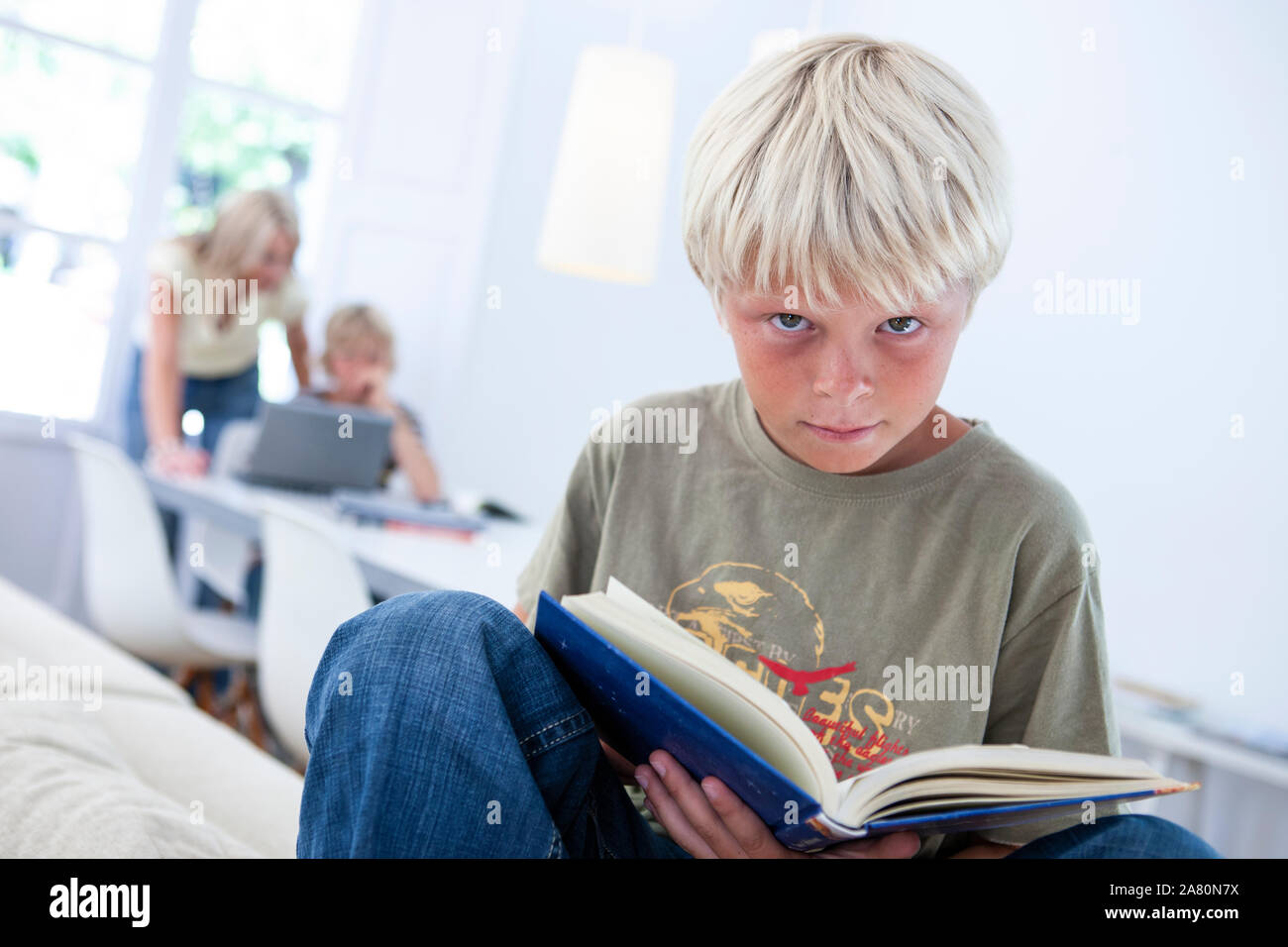 Young boys reading at home Stock Photo - Alamy