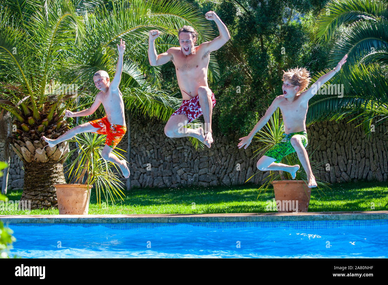 Family jumping into pool hi-res stock photography and images - Alamy