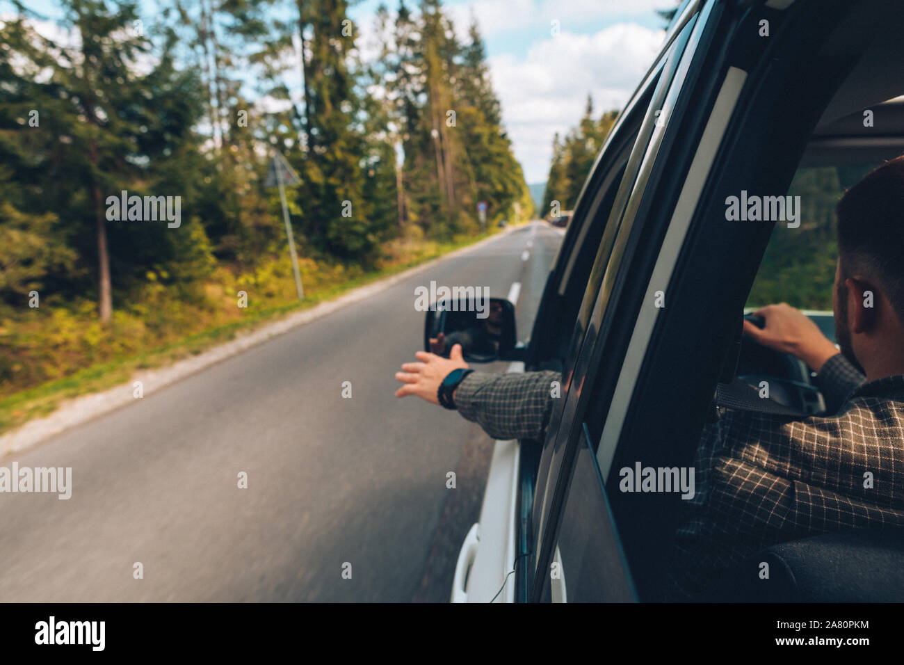man catch wind with hand wile driving car Stock Photo - Alamy