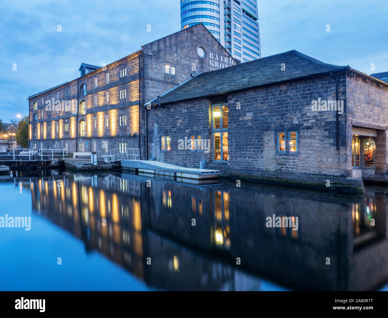 Floodlit Canal Warehouse reflected in the Leeds and Liverpool Canal at ...