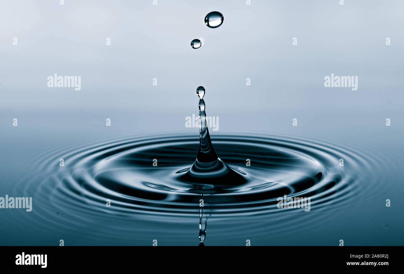 Water drop falling into water making a perfect droplet splash Stock ...