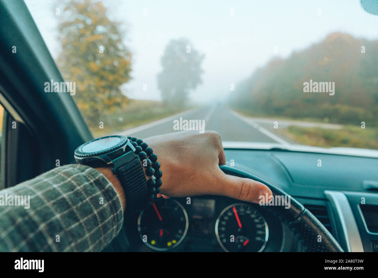 car travel concept man hand on steering wheel speedway Stock Photo - Alamy