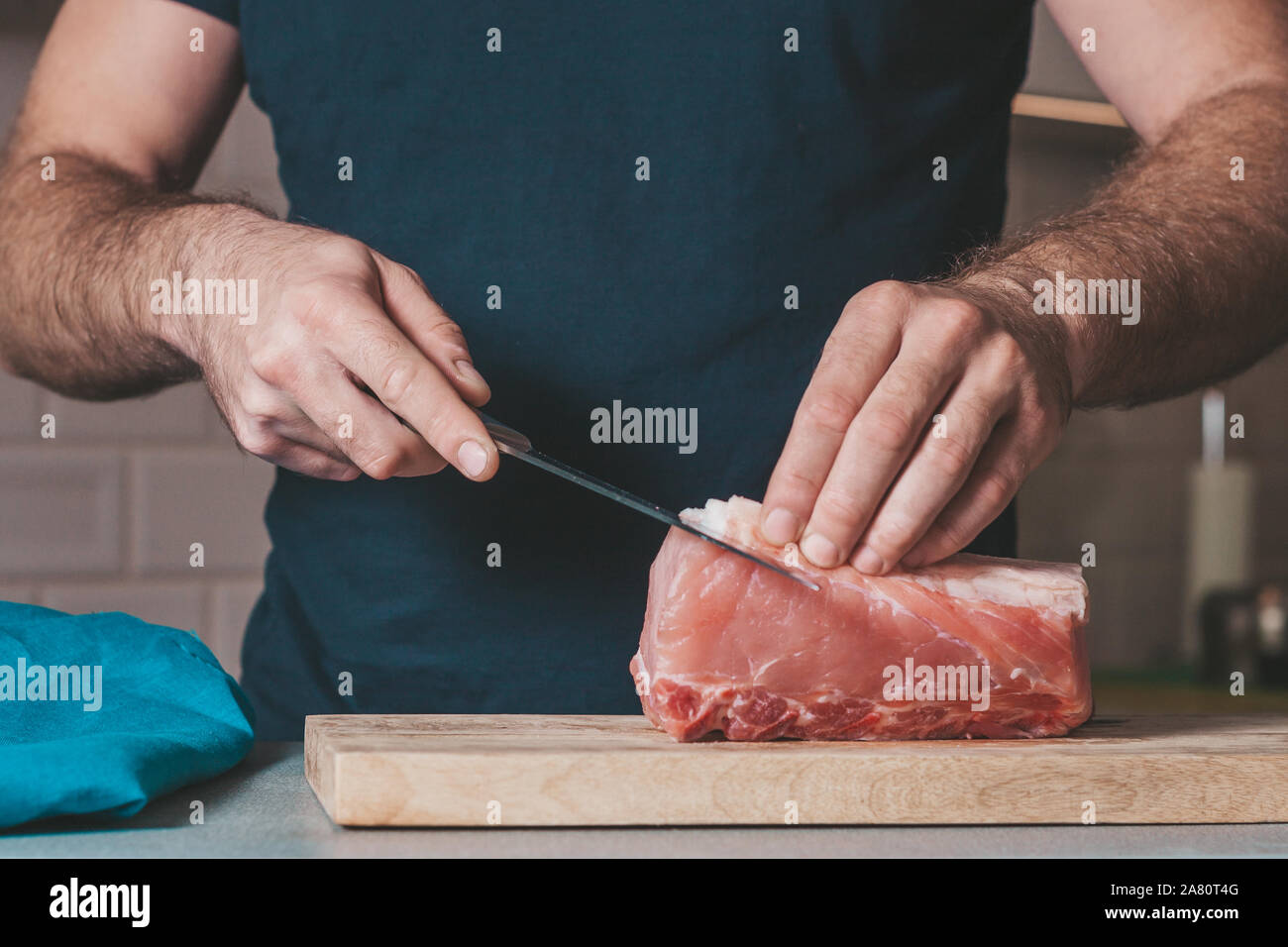 A man cooks pork in the kitchen Stock Photo - Alamy