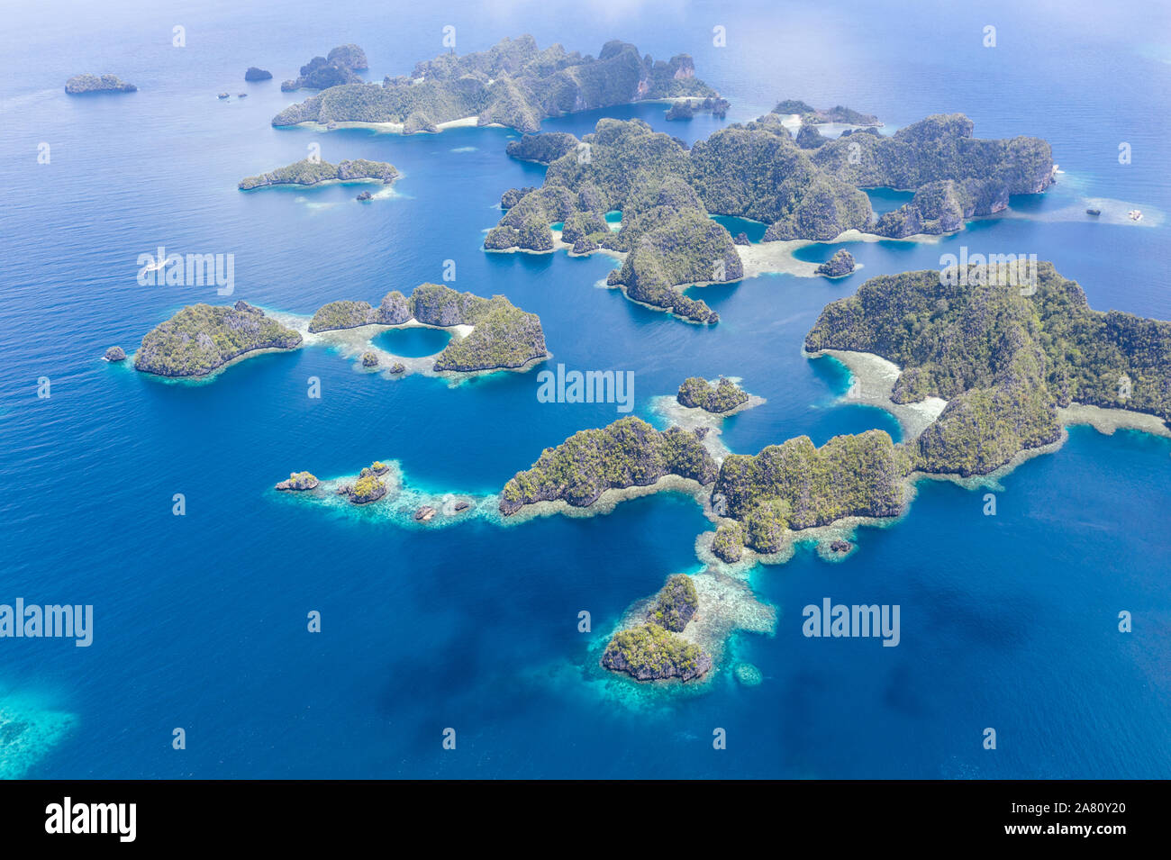 Highly eroded limestone islands rise from the beautiful, tropical ...
