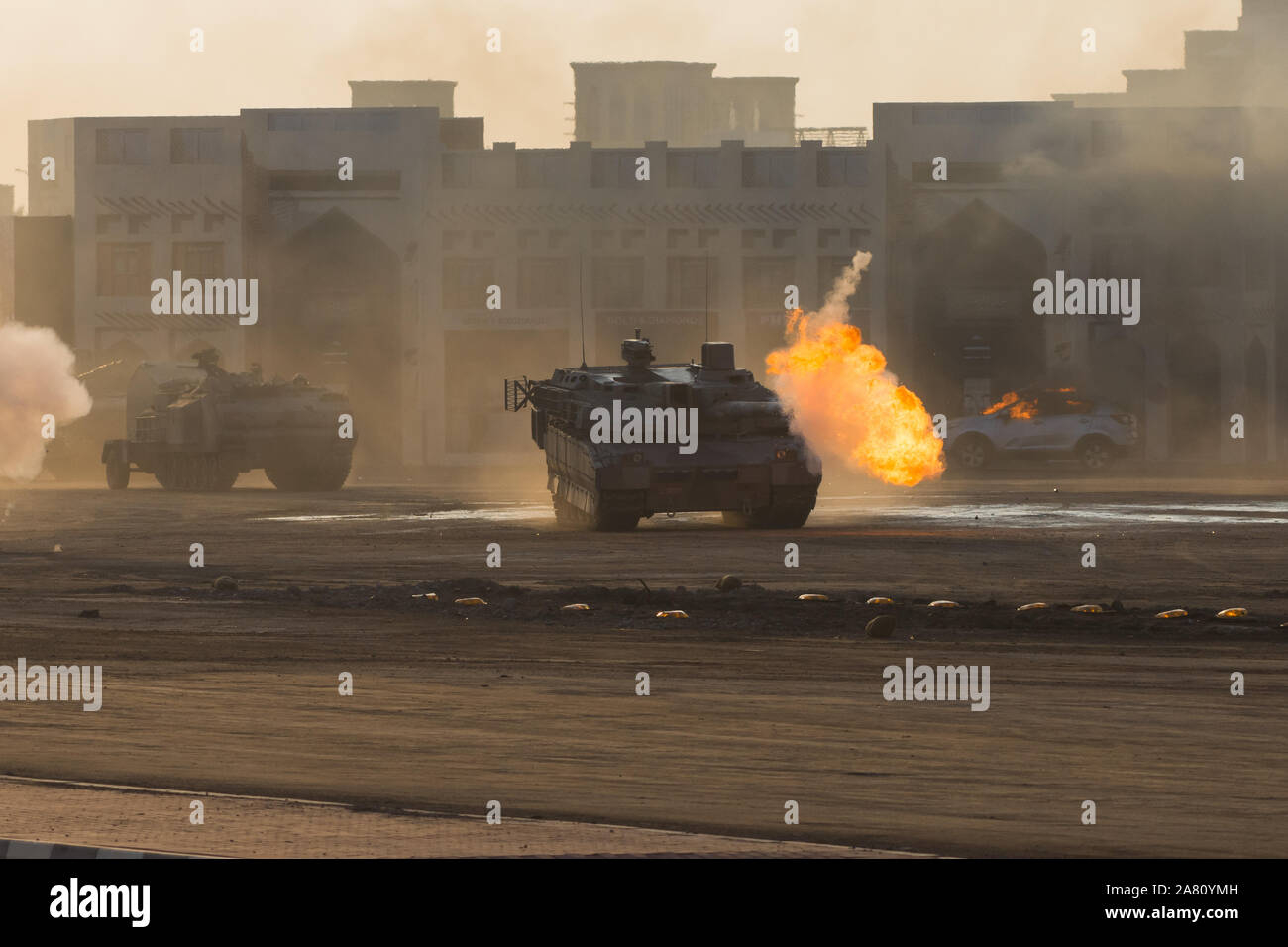Army tanks shooting and driving in the desert town in war and military ...