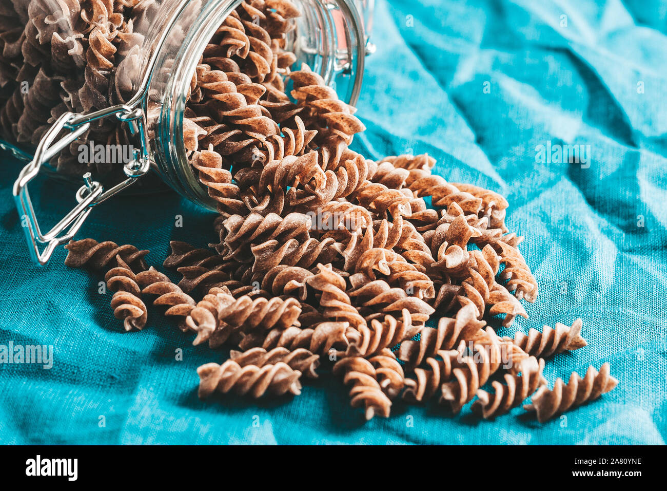 Dark brown pasta in a glass jar in the kitchen Stock Photo - Alamy